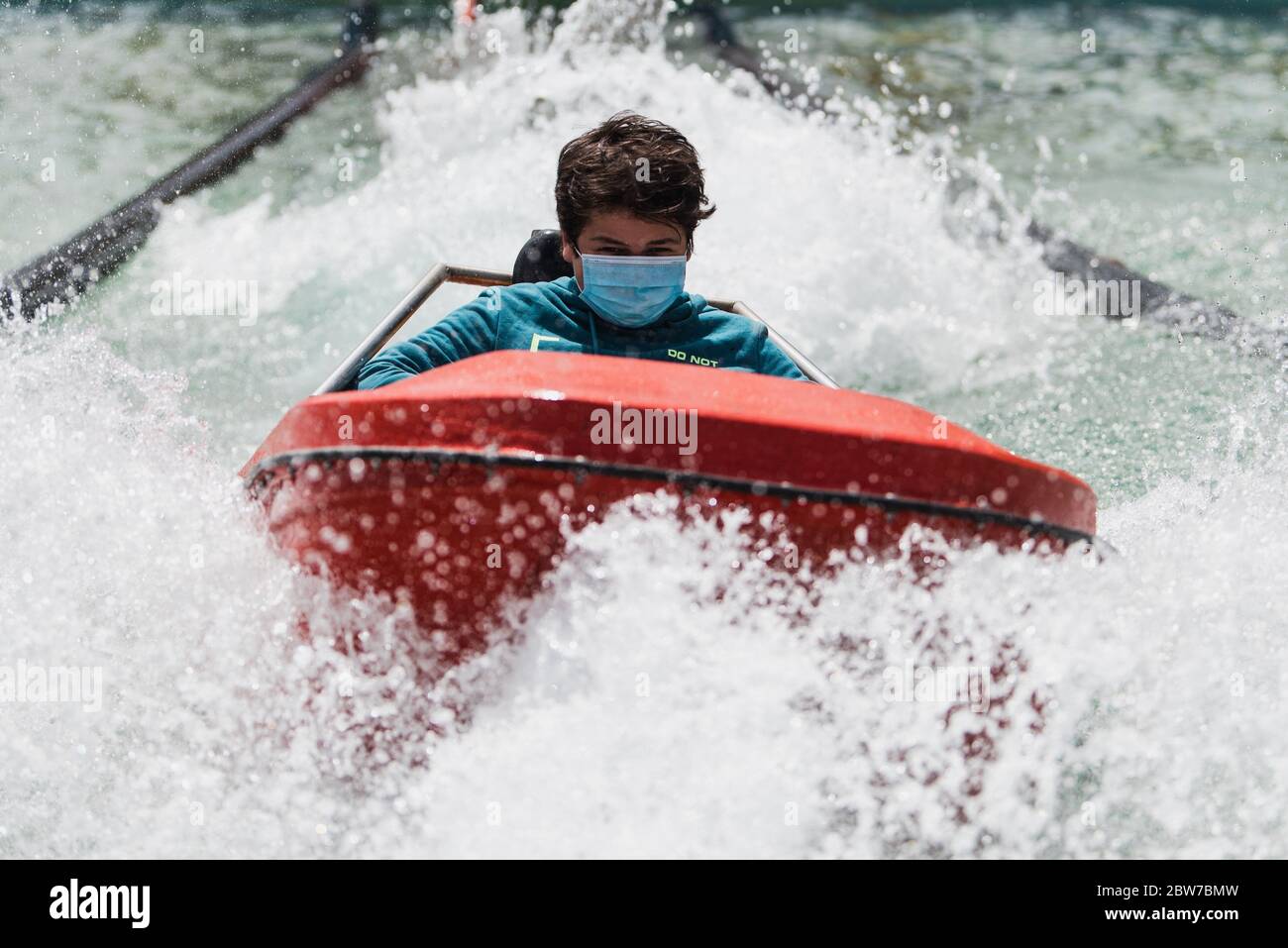 30 May 2020, Bavaria, Geiselwind: Noah rides the water slide ...