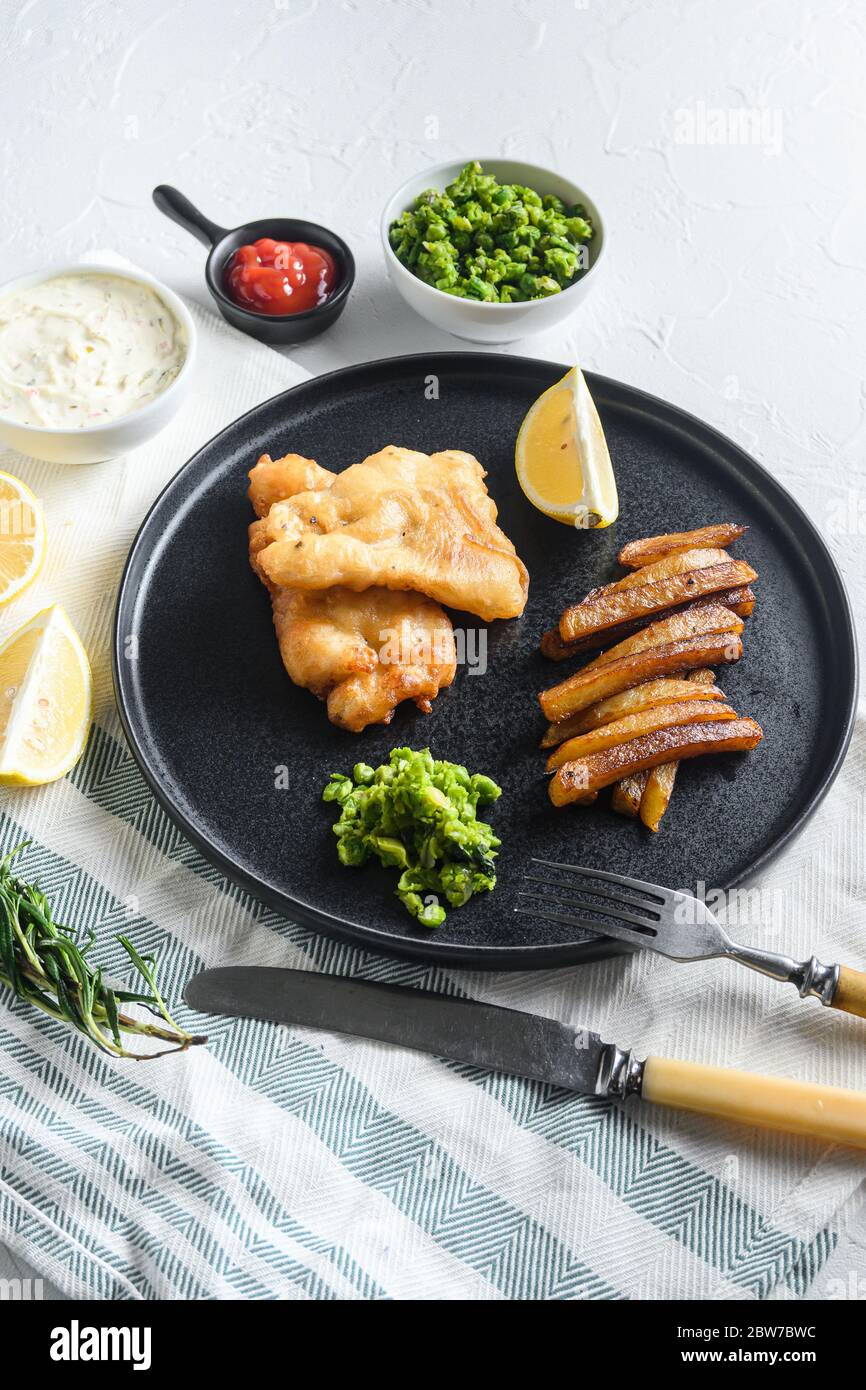 crispy fish and chips with battered cod and fries and a side of tartar ...