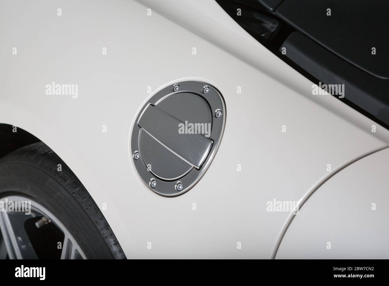 Metallic fuel cap on a white sports car Stock Photo - Alamy