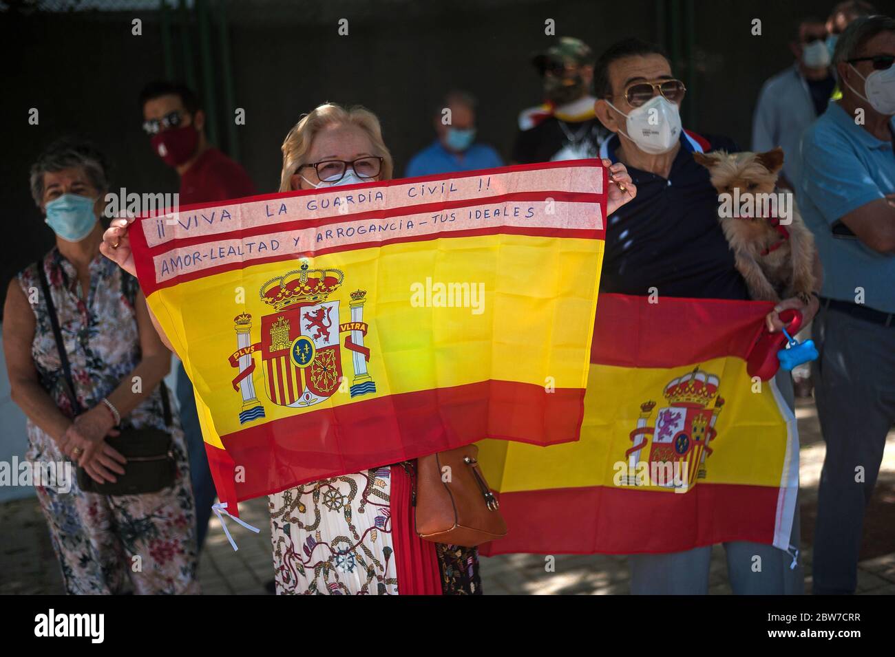 Supporters hold Spanish flags as they protest in support of Spanish ...