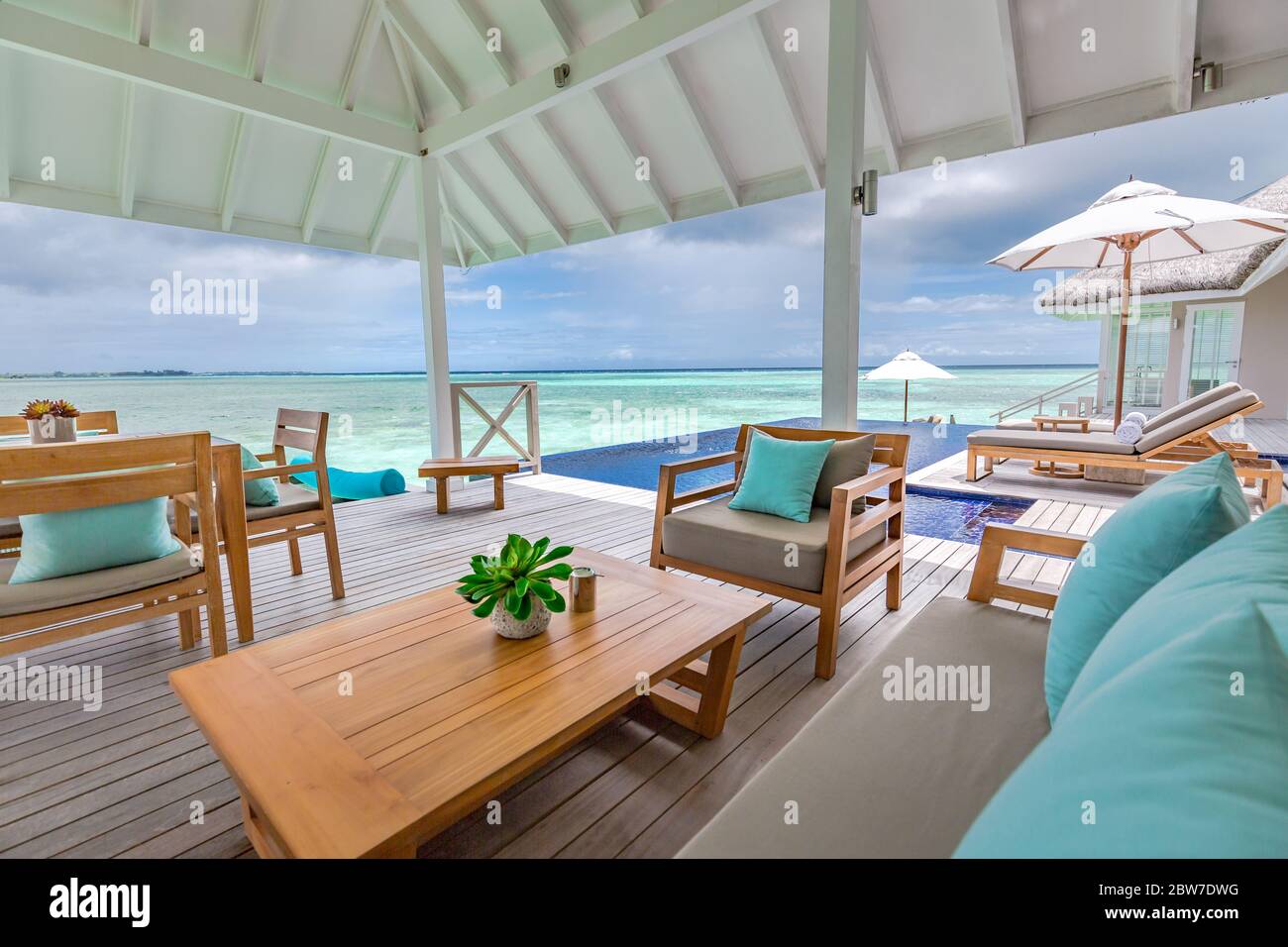 Luxury swimming pool near beach front, view from over water wooden ...