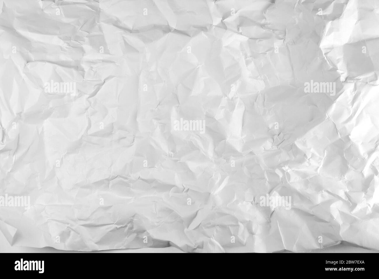 Top view closeup sheet of white crumpled uneven paper. Abstract modern ...