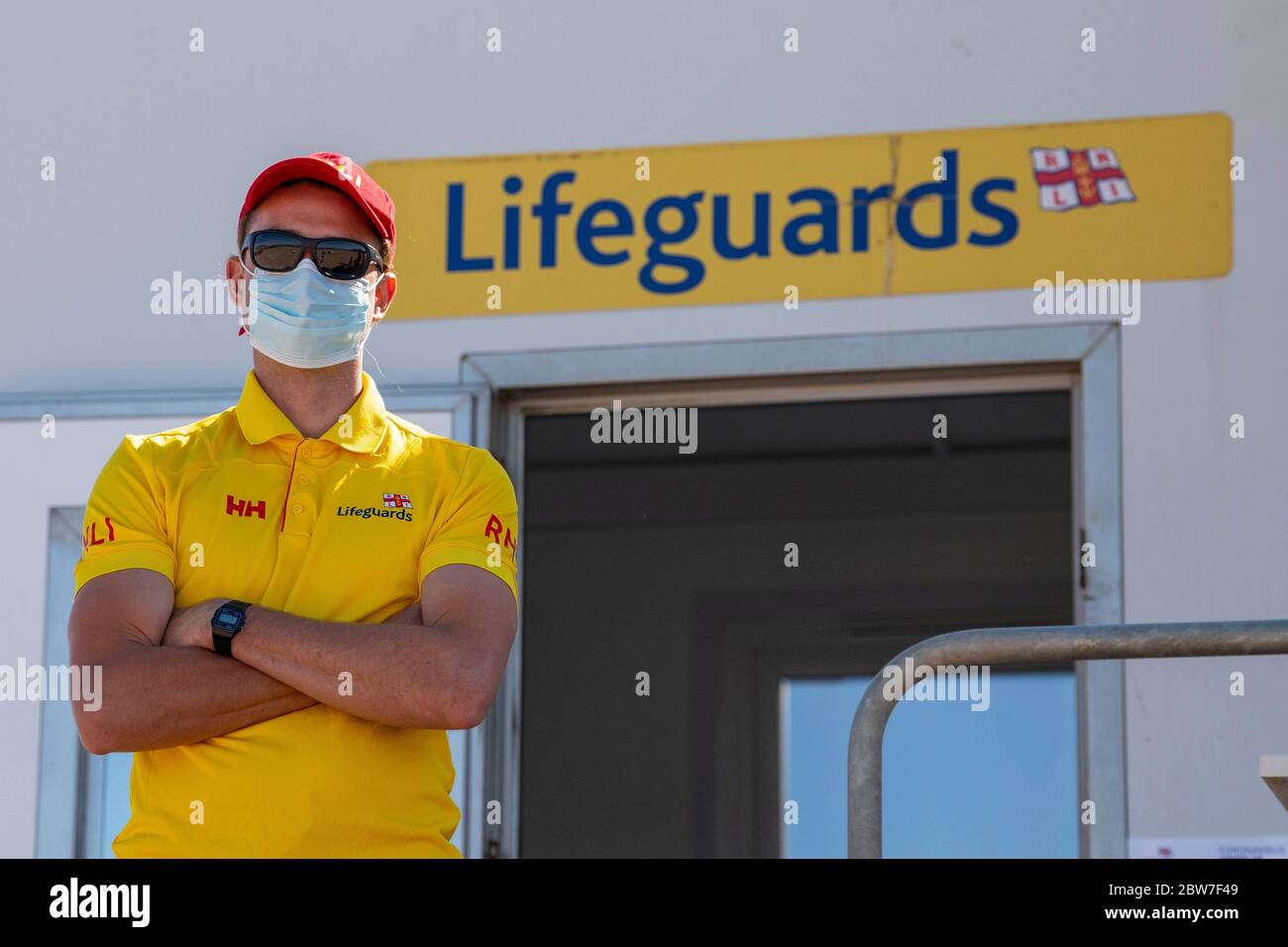 RNLI Lifeguards resume patrols on the beach at Croyde in Devon wearing ...