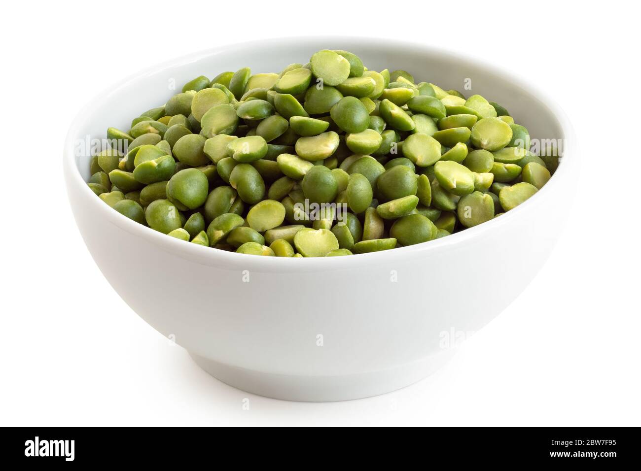 Dried green split peas in a white ceramic bowl isolated on white. High ...