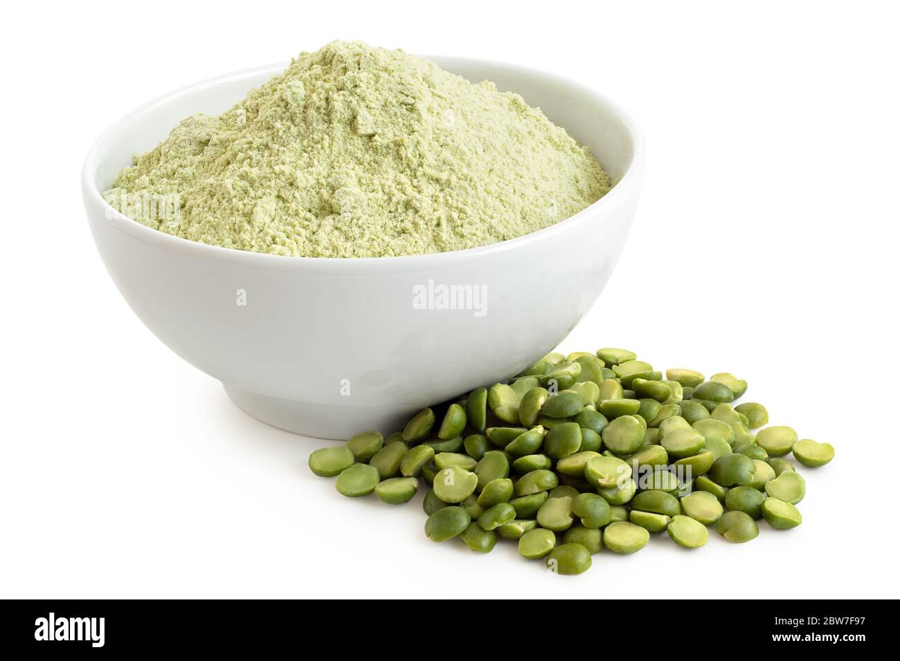 Dried green pea flour in a white ceramic bowl next to a pile of green ...