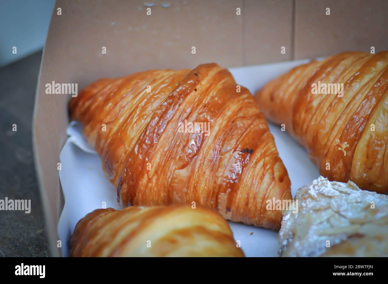 croissant and almond croissant in the box Stock Photo - Alamy