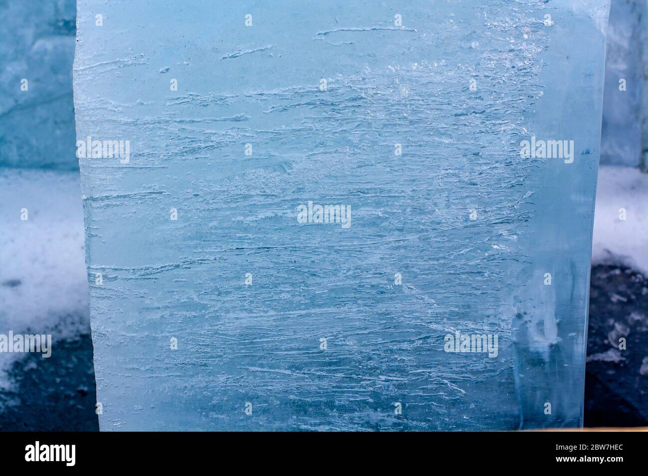 Thick piece of ice with a melting structure. Bubbles of air and thin ...