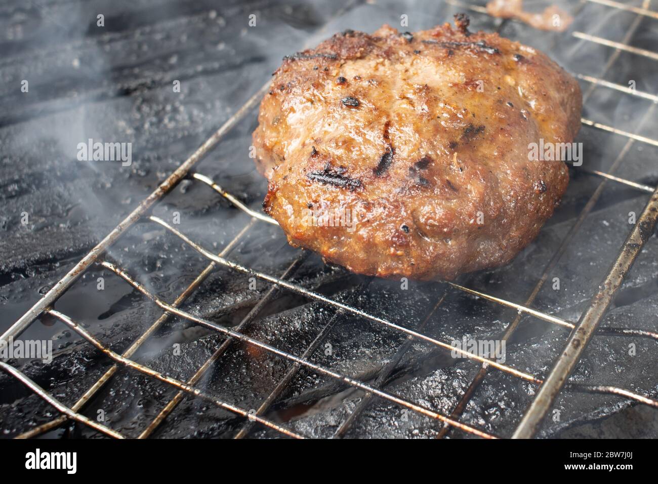 cooking burgers on hot grill with flames Stock Photo - Alamy