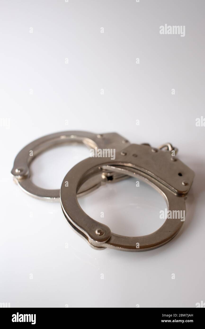 steel metal Handcuffs on white background isolate Stock Photo - Alamy