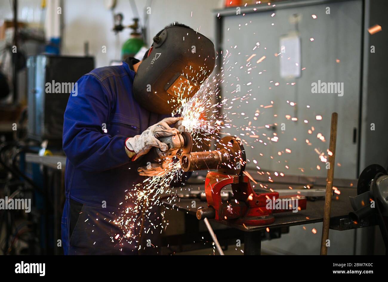 Worker operating an angle grinder and making lots of sparks Stock Photo ...