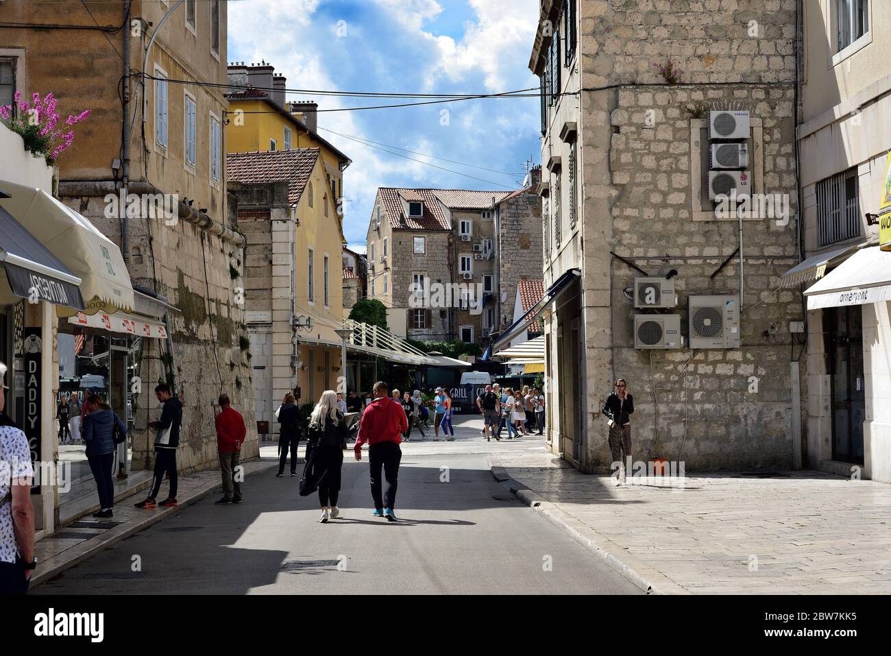 SPLIT, CROATIA - APRIL 29, 2019: A crowd of tourists walking down the ...