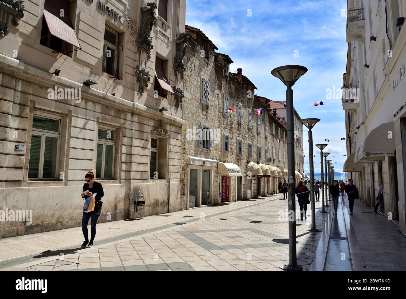 SPLIT, CROATIA - APRIL 29, 2019: A crowd of tourists walking down the ...