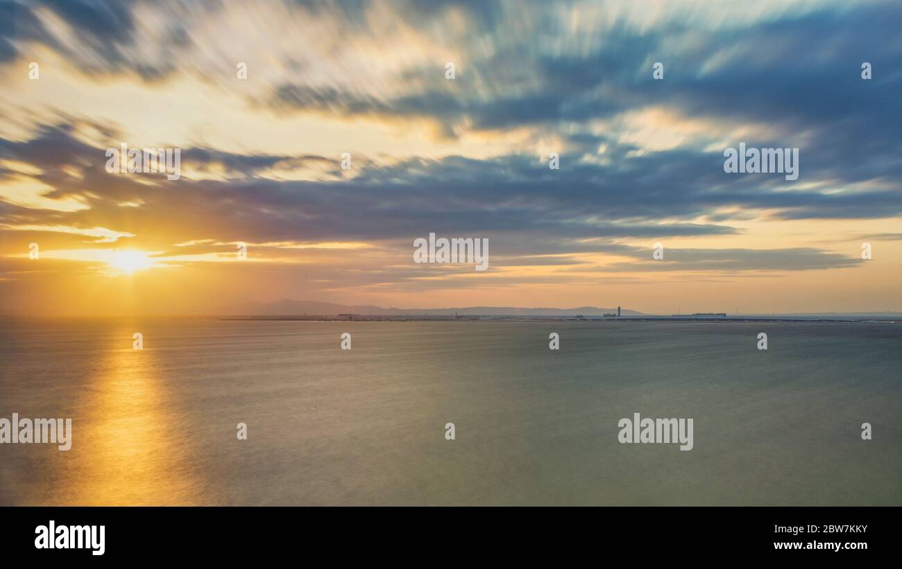 Sunset over the ocean in Osaka Bay with dramatic sky and clouds, Osaka ...