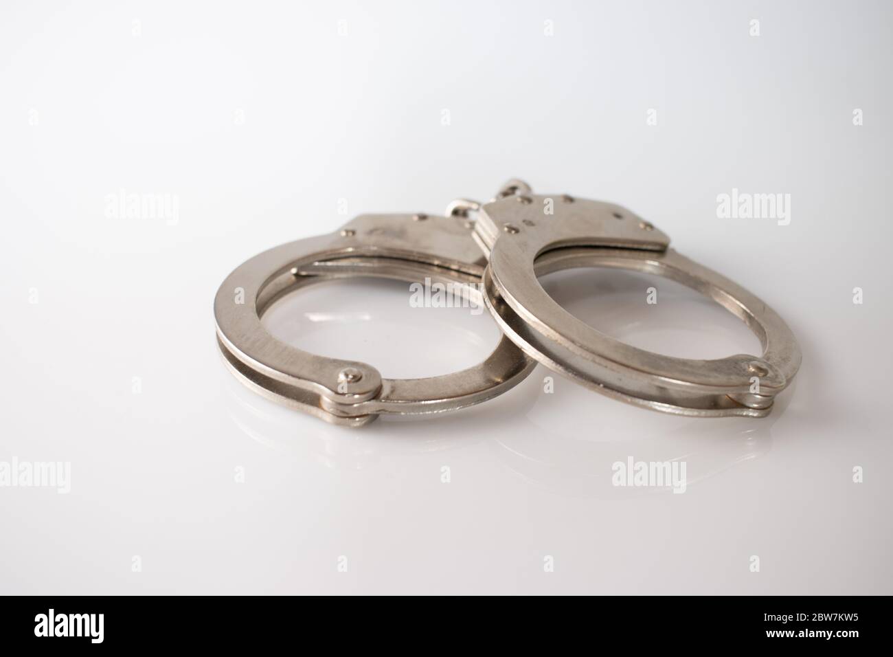steel metal Handcuffs on white background isolate Stock Photo - Alamy