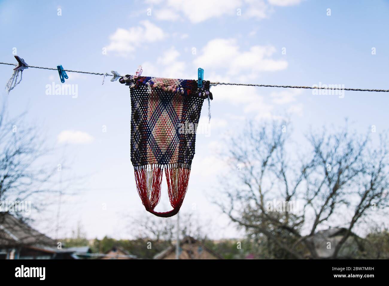 Colorful eco bad hanging outside after washing Stock Photo - Alamy