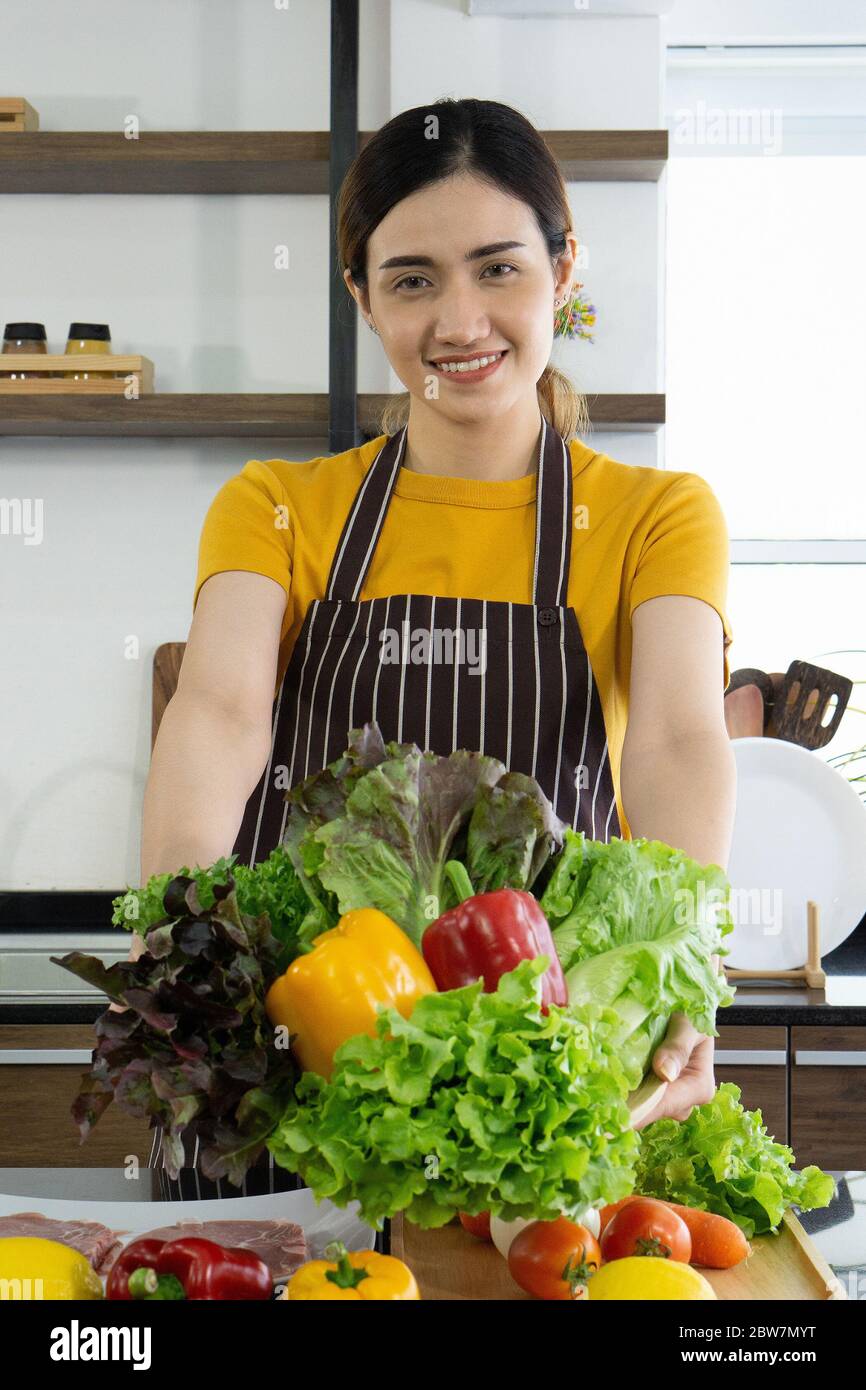 Young housewife smiled and offered a basket full of various kinds of ...