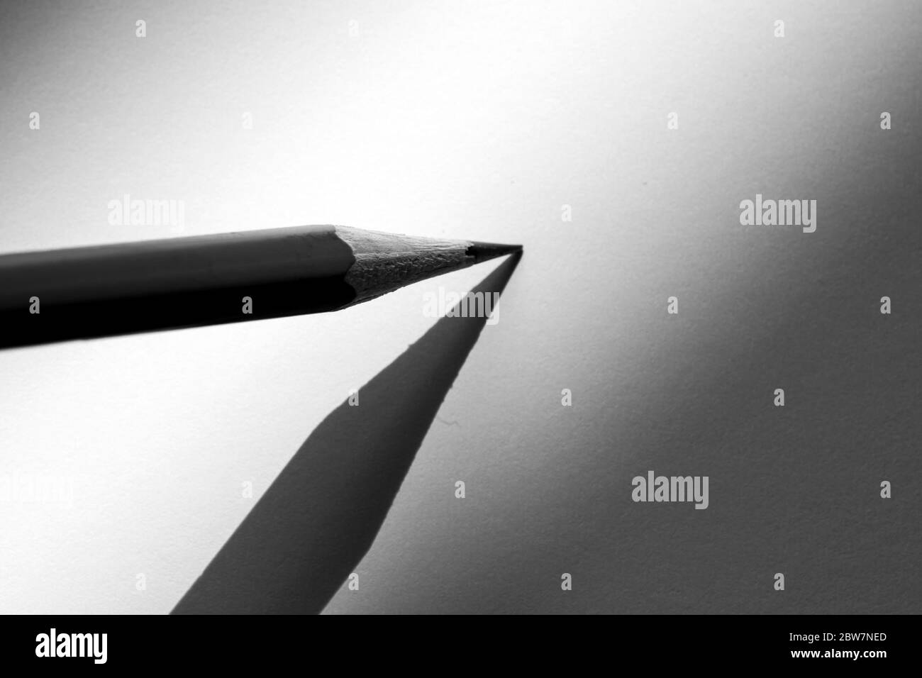 The pencil holding to write on the paper in shadow Stock Photo - Alamy