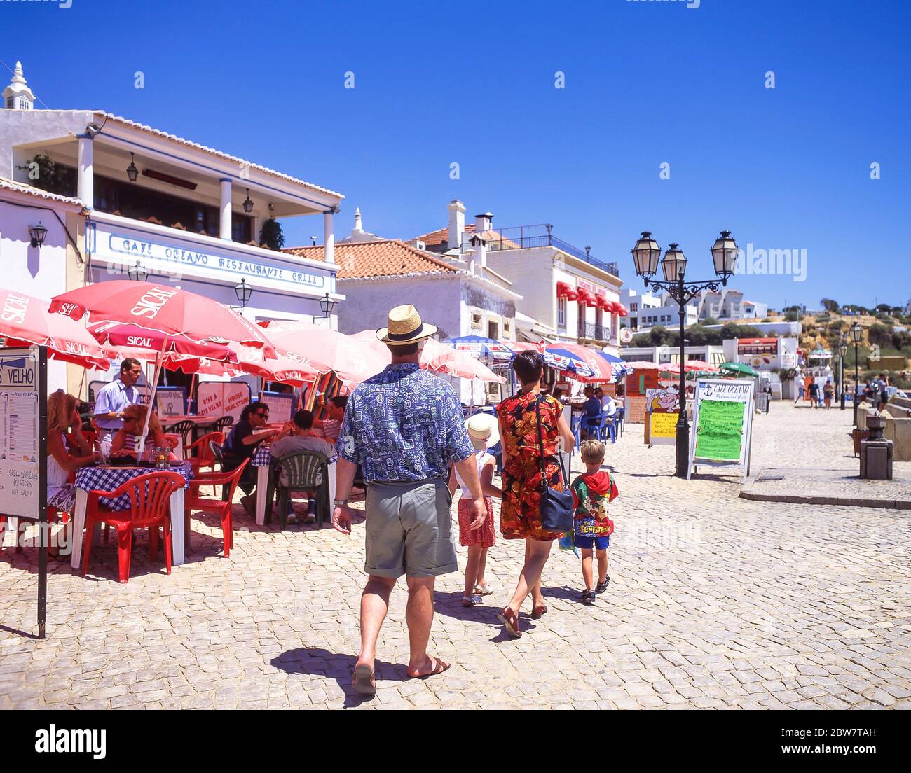 Family walking on beach promenade, Praia de Albufeira, Albufeira ...