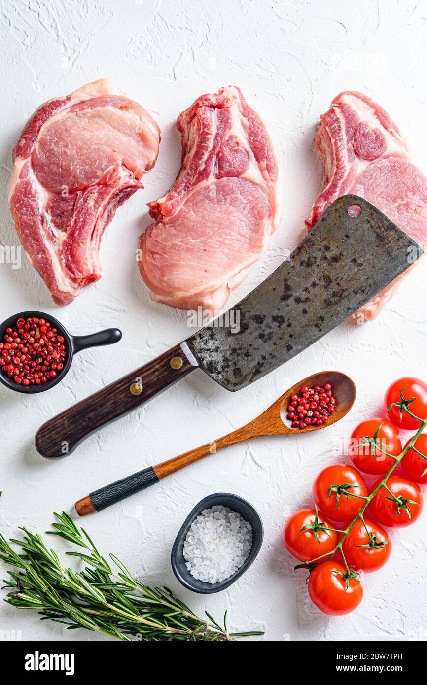 Set for bio grilling butcher cleaver over organic bio Raw pork chops ...