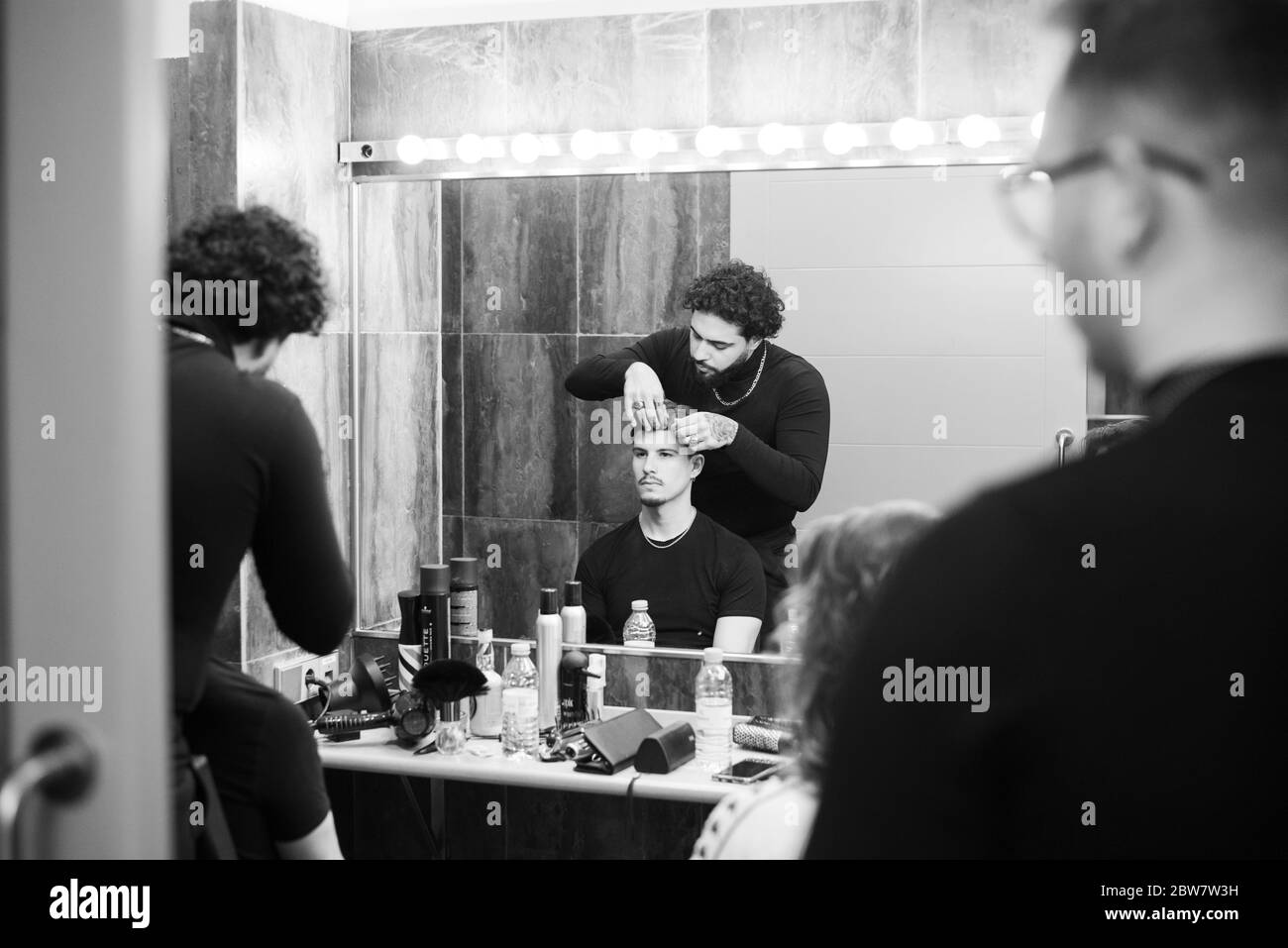Barber and customers with a mirror Stock Photo - Alamy