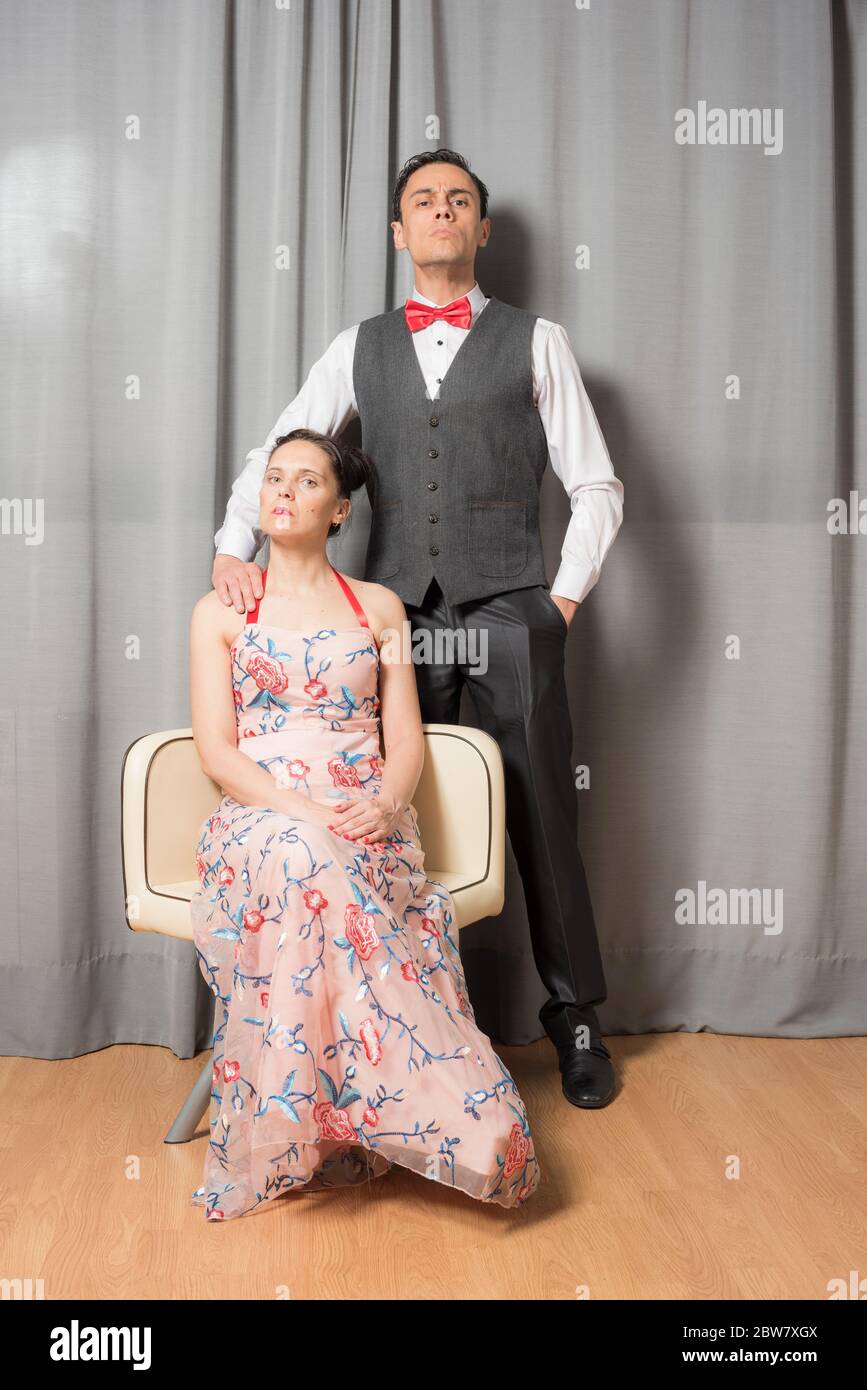 Solemn portrait of Marriage. The woman, seated in an elegant flowered ...