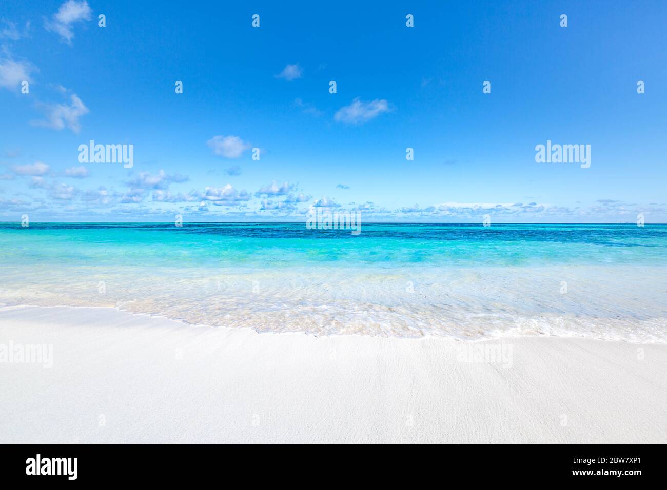 Empty tropical beach with soft waves splashing background. Horizon with ...