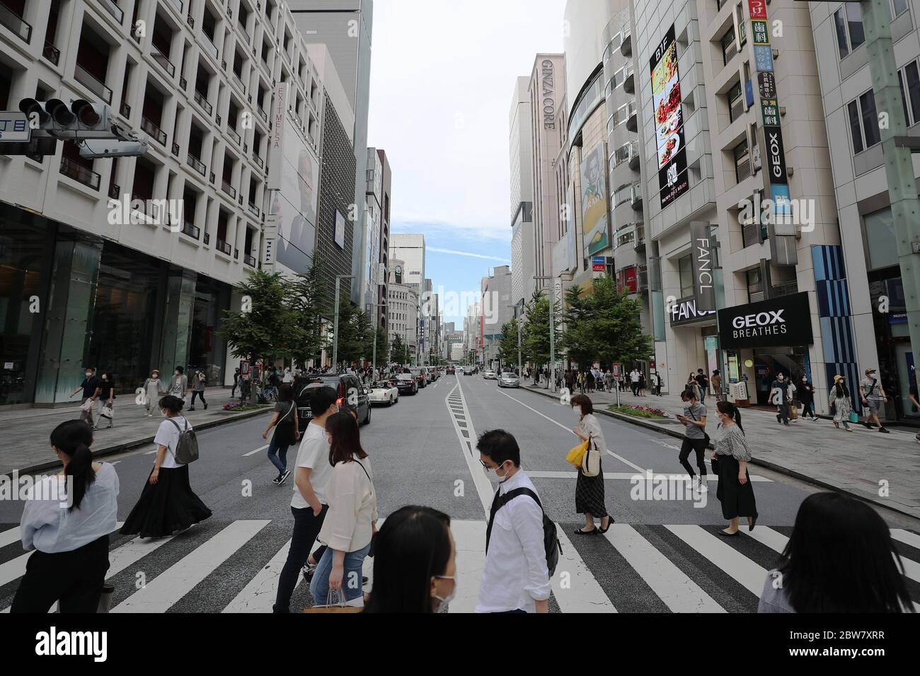Tokyo, Japan. 30th May, 2020. People wearing face masks walk in a ...