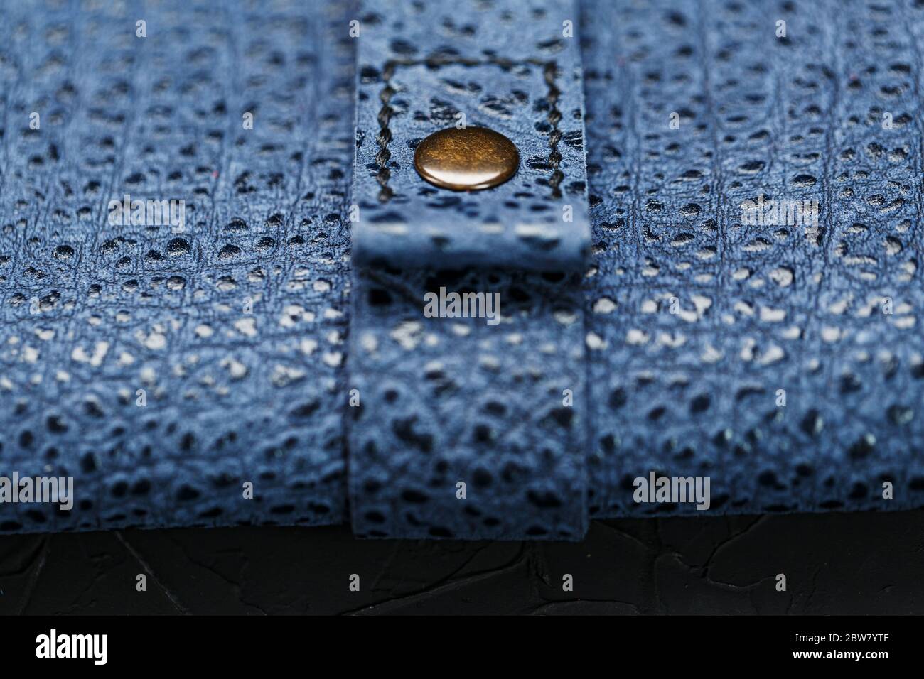 Blue purse made of textured leather on a black background Stock Photo ...
