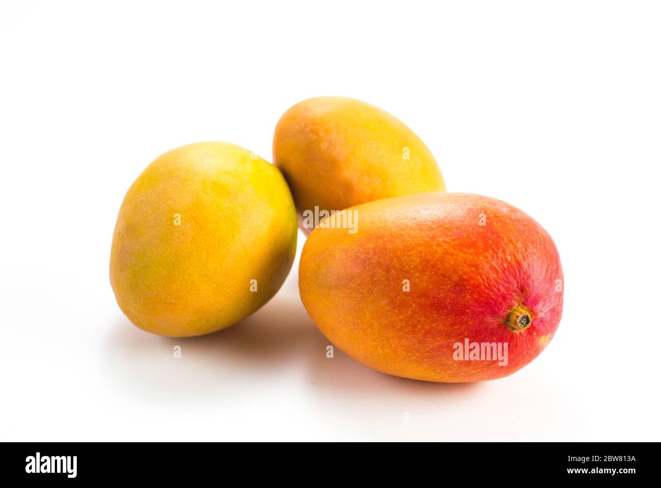 Three ripe tropical fruit mango isolated on white closeup Stock Photo ...