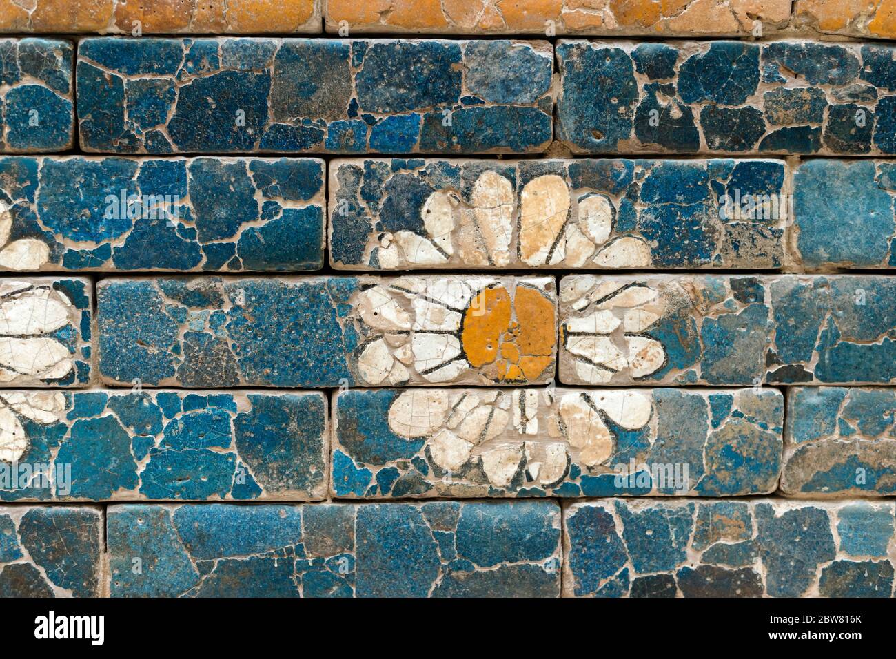 ancient Babylonian glazed brick wall with white flower decoration Stock ...