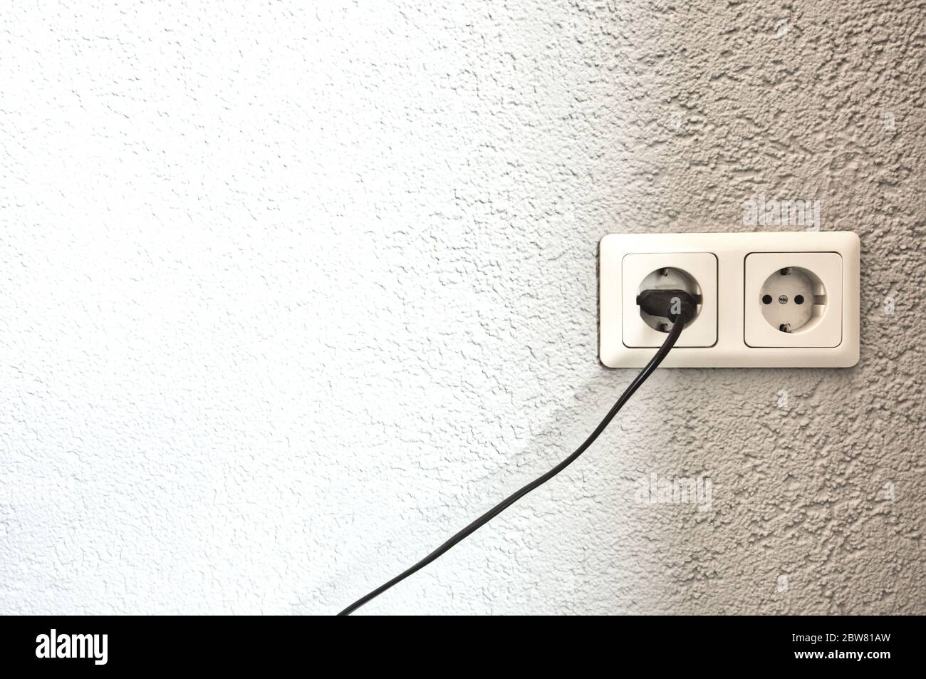 Double electrical power European socket with black cable and plug on ...