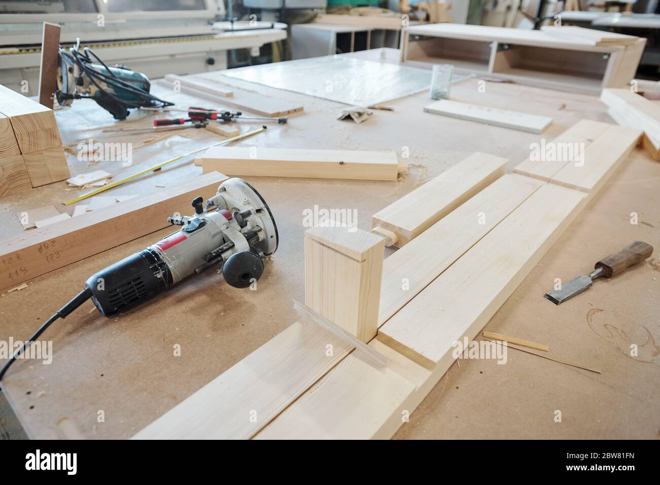 Large workbench of modern furniture factory workers with several ...