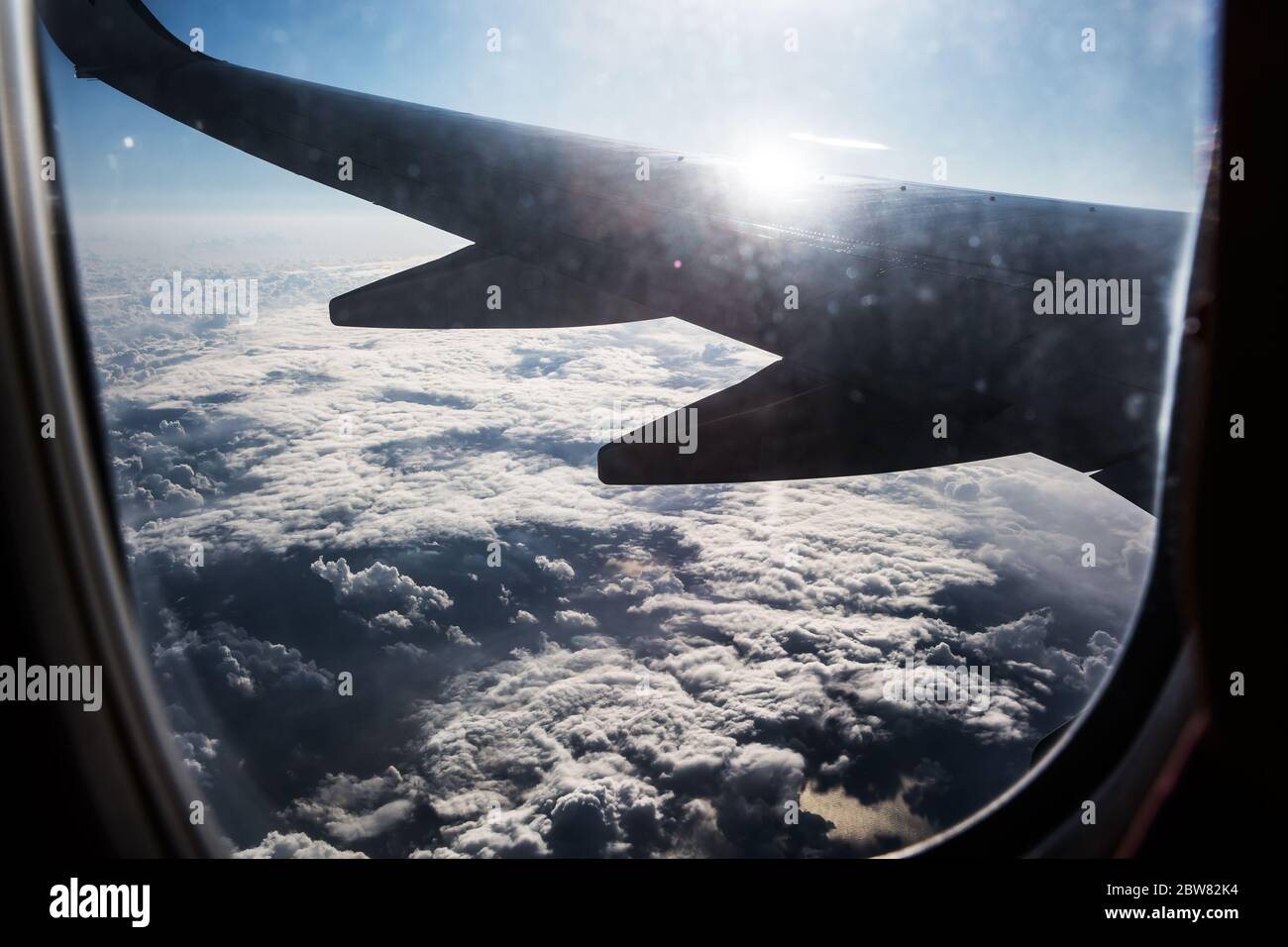 Flying and traveling, view from airplane window on the wing on sunset ...