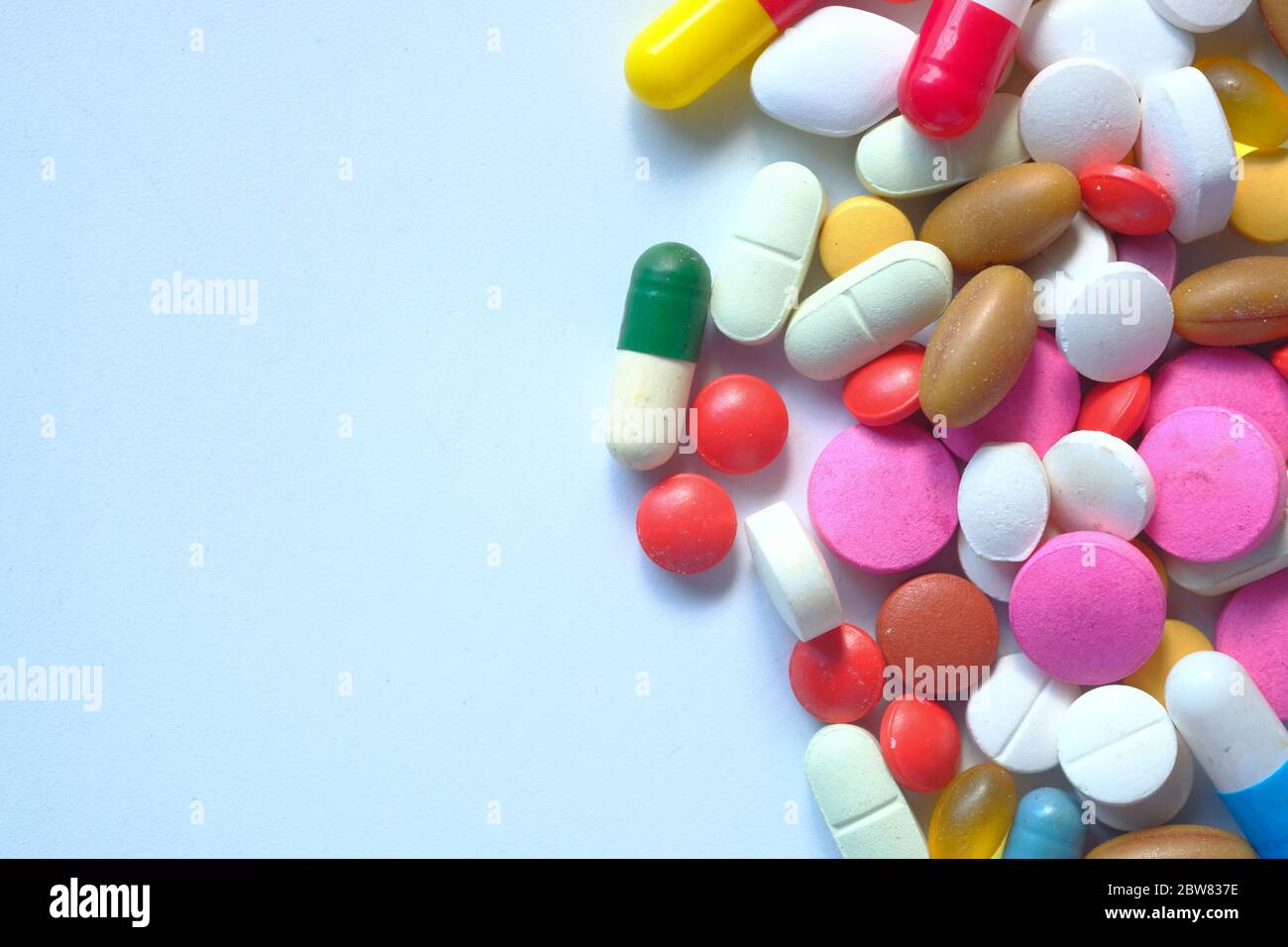 Close up of colorful pills on white with copy space Stock Photo - Alamy