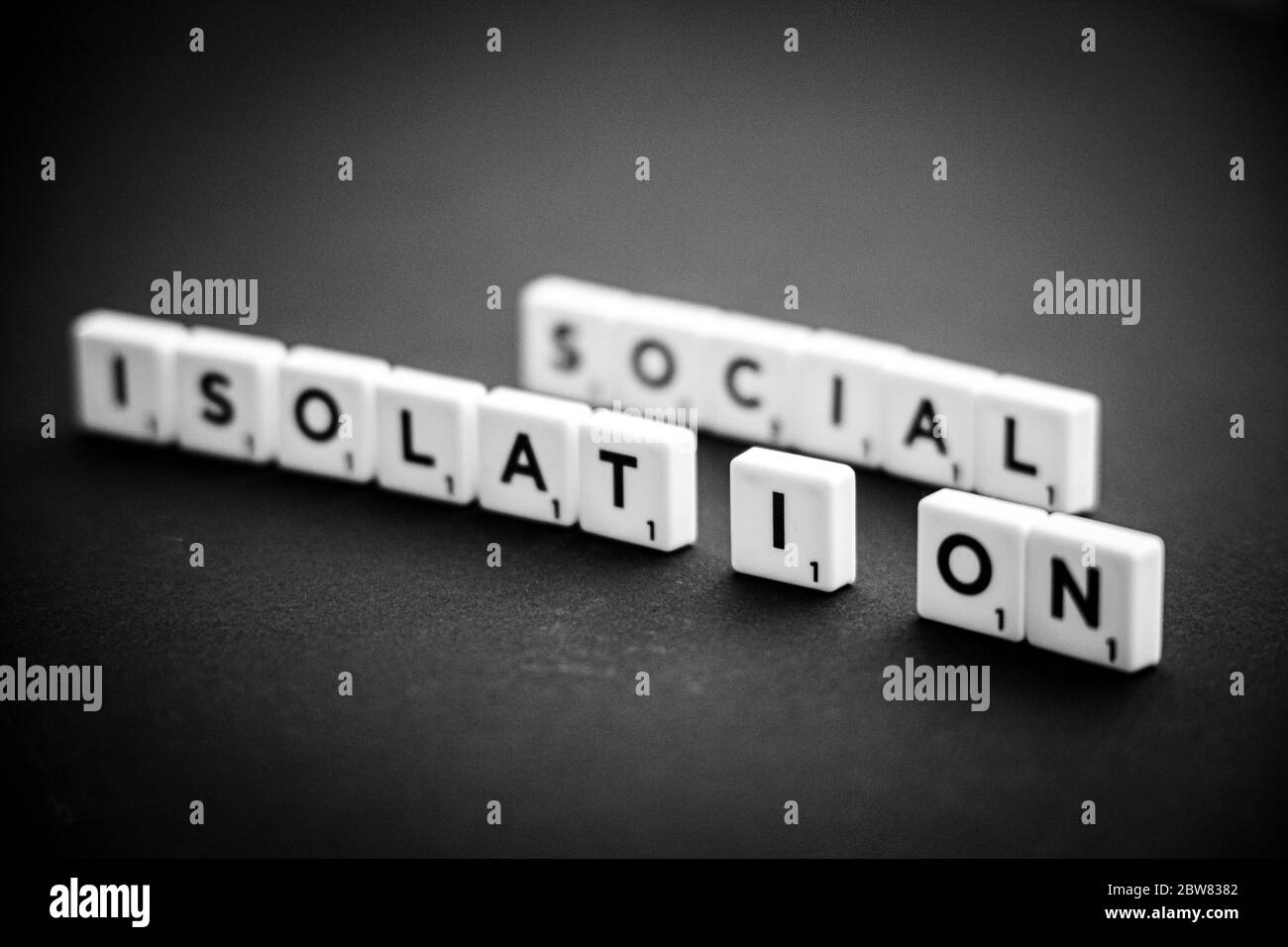 Images of social distancing and isolation using scrabble letters and ...