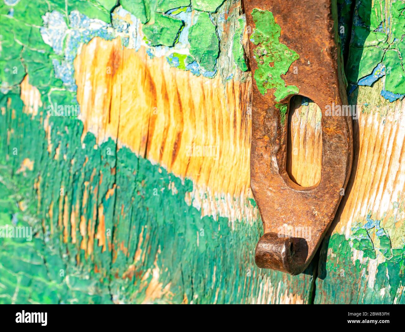 Fastening a metal hinge for a padlock of a wooden door Stock Photo - Alamy
