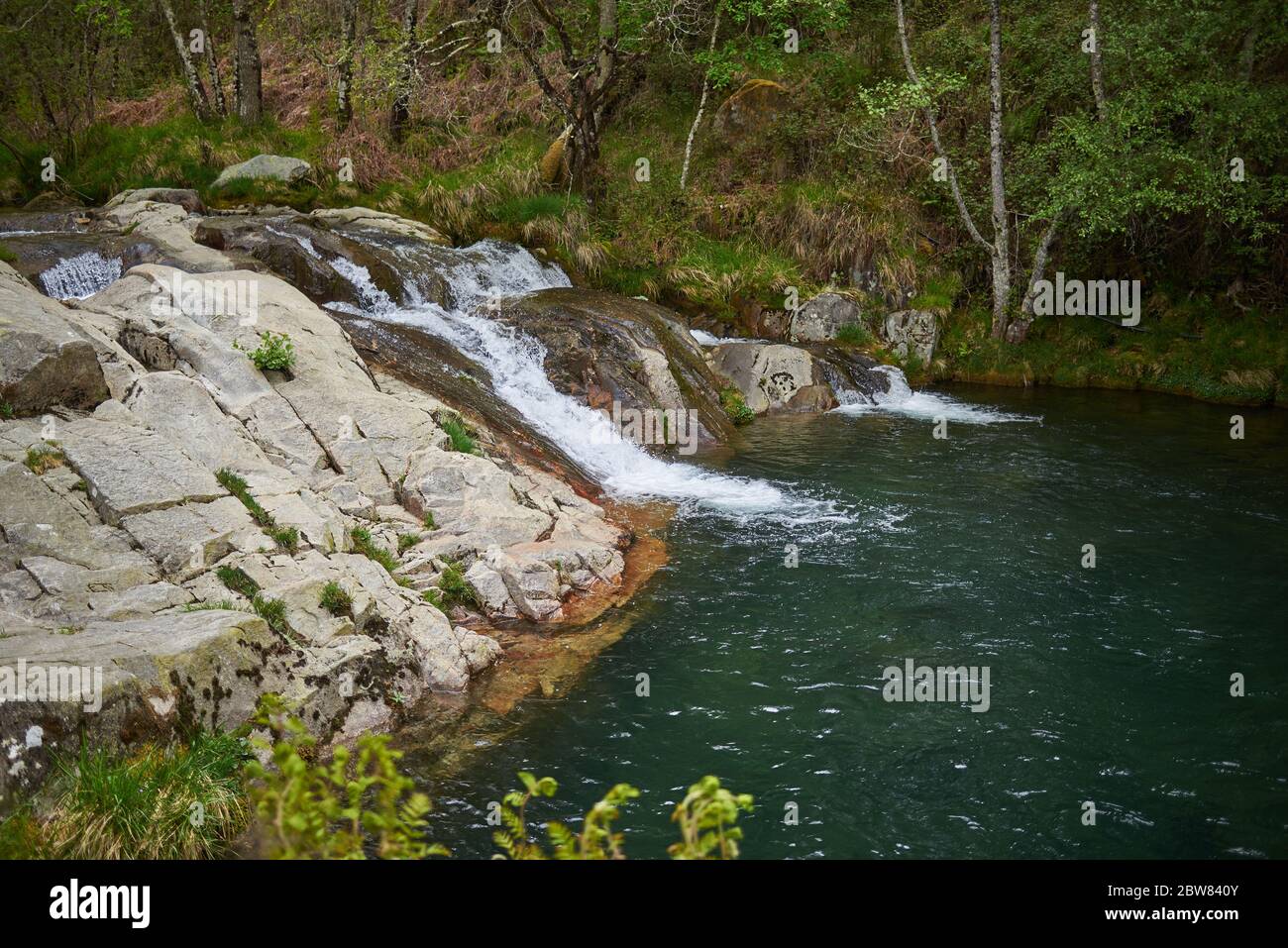 Natural pool with a waterfall Stock Photo - Alamy