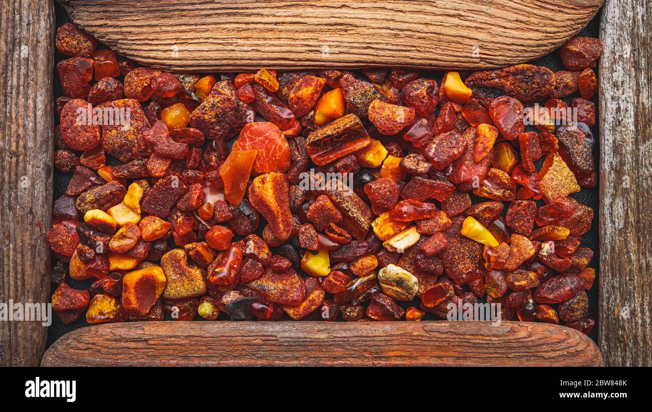 Amber stones framed in a wooden frame, background for design Stock ...