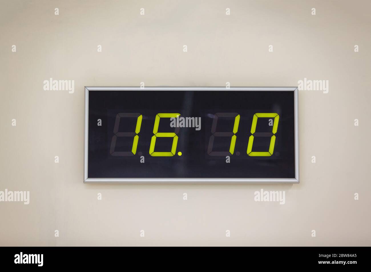 Black digital clock on a white background showing time 16:10 Stock ...