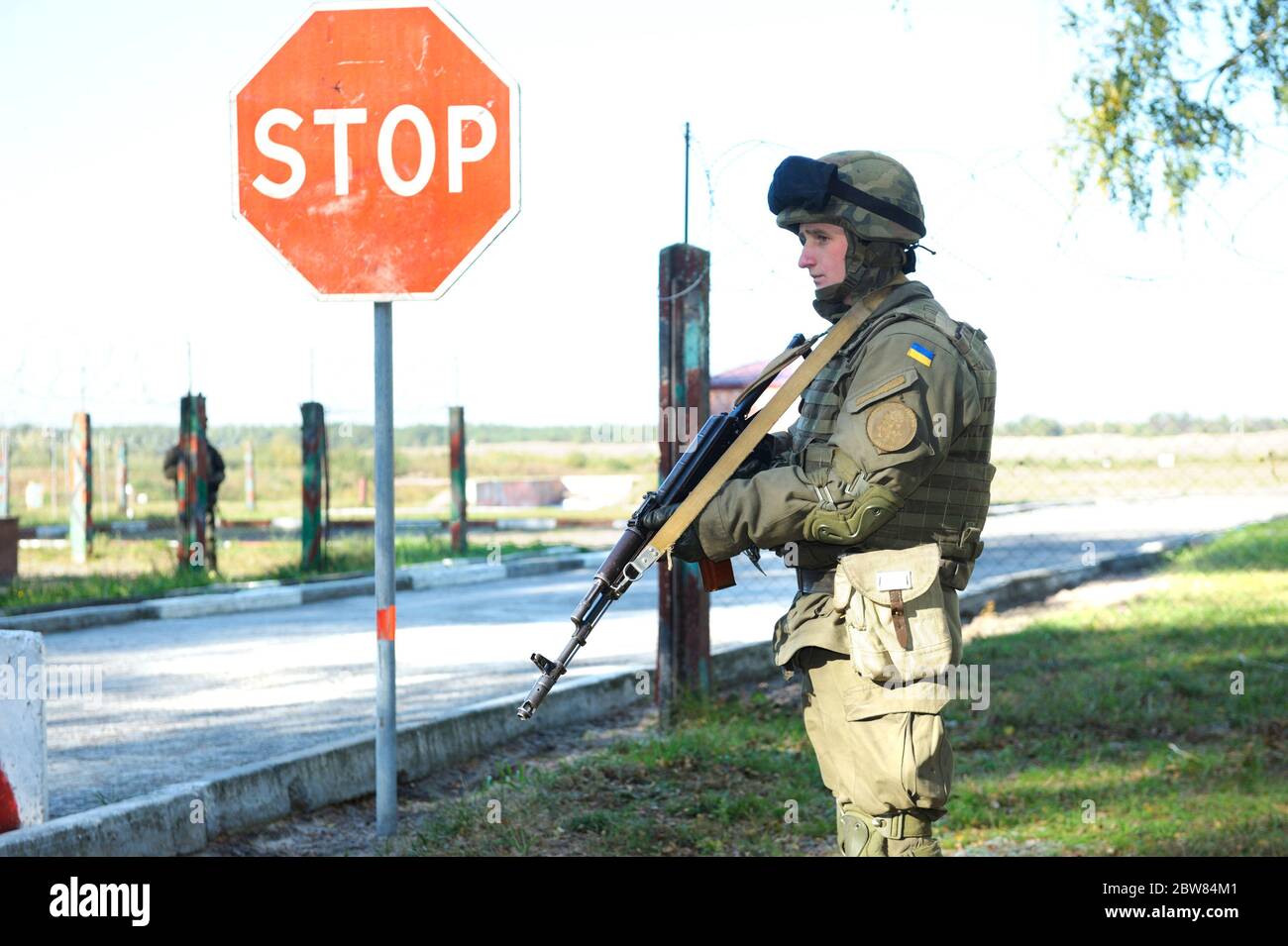 Fully equipped soldiers guarding the checkpoint in front of the sign ...