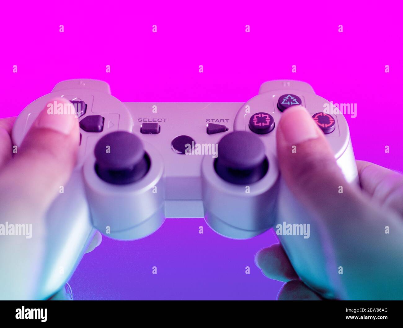 Hands of a black woman holding a video game controller. Selective focus ...