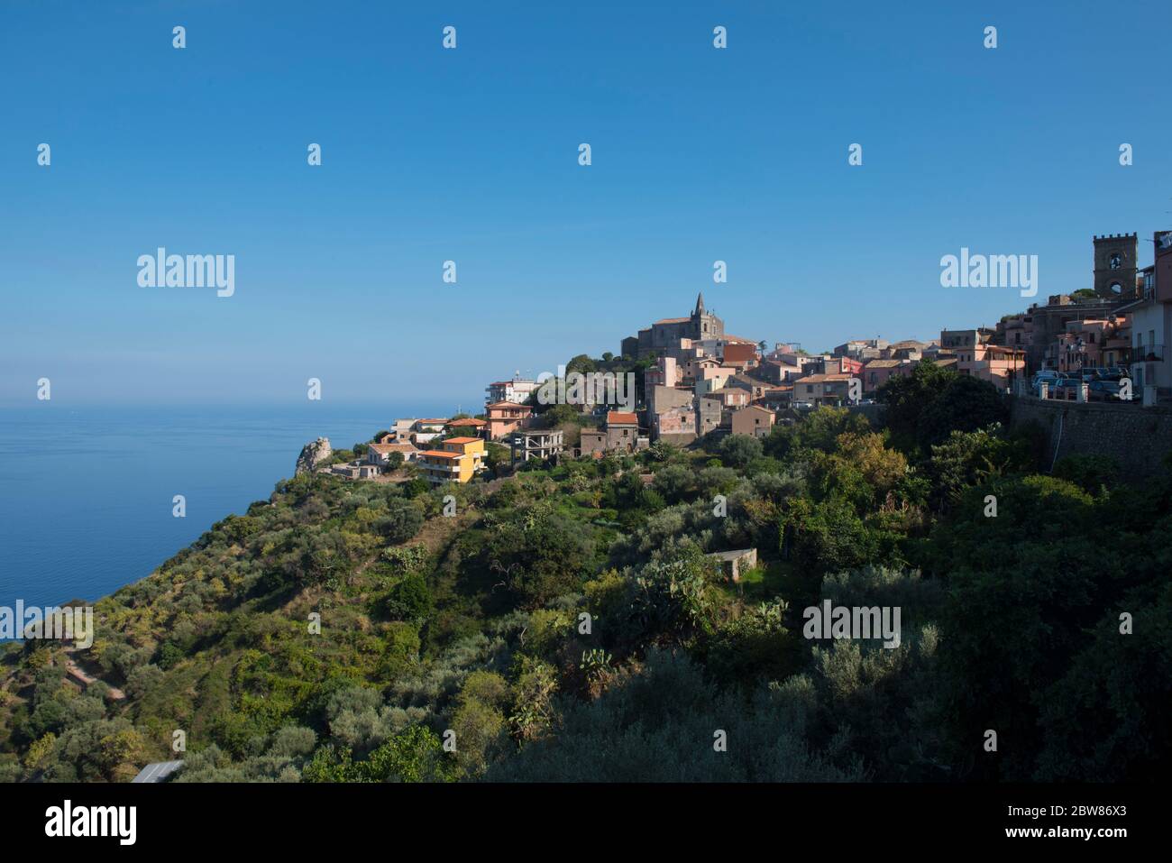 A small hill top town in the afternoon sunshine with the blue sky and ...