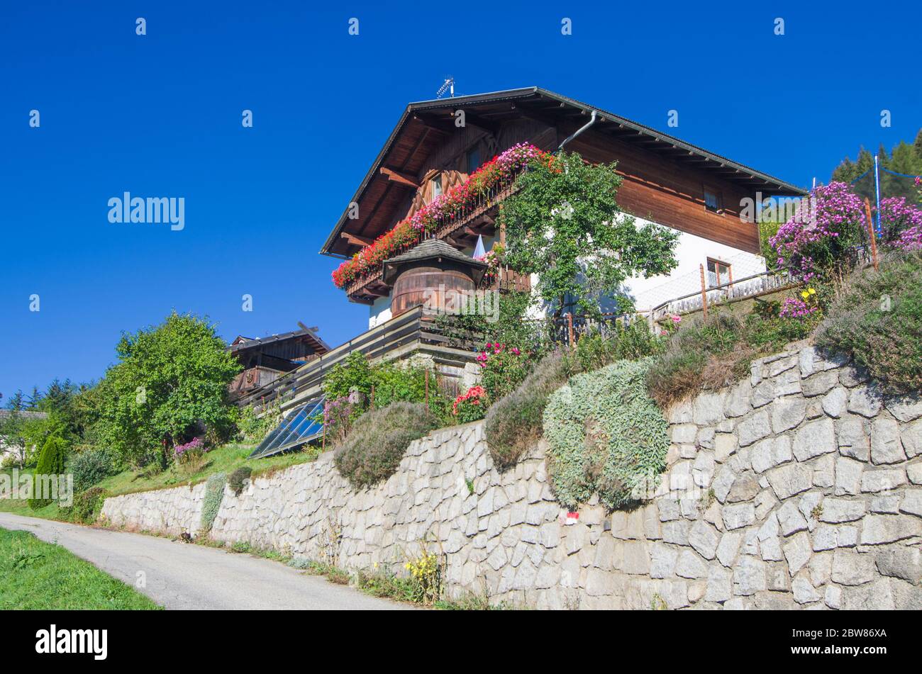 historical and typical mountain building in stone, white plaster and ...