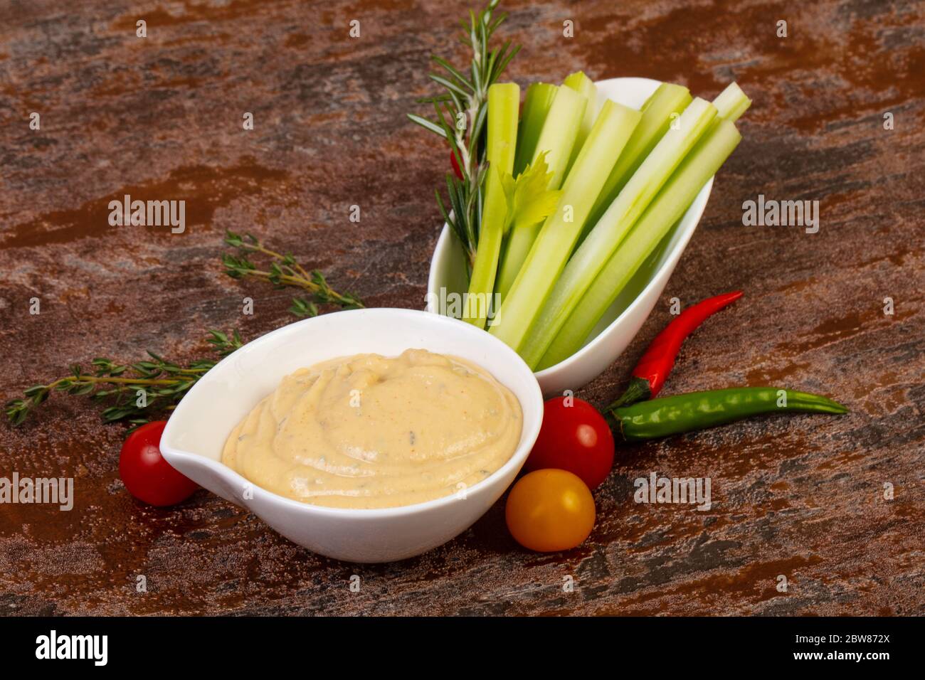 Vegan cuisine - Humus with celery sticks Stock Photo - Alamy