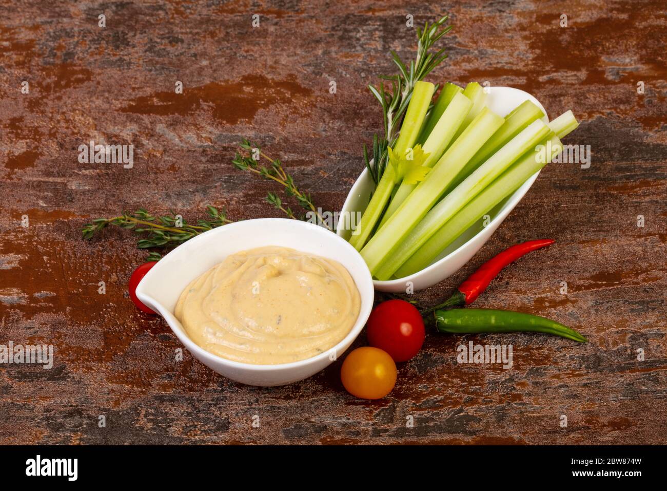 Vegan cuisine - Humus with celery sticks Stock Photo - Alamy