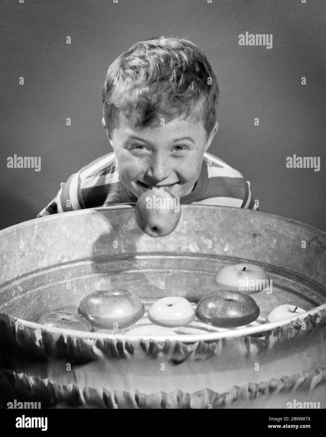 Boy bobbing for apples hi-res stock photography and images - Alamy