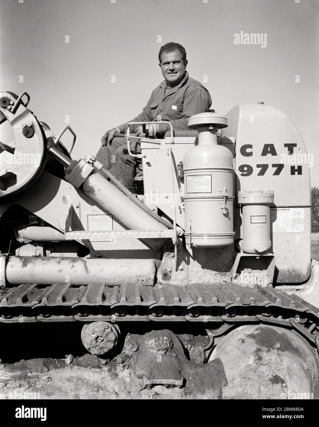 1960s SMILING MAN CONSTRUCTION EQUIPMENT OPERATOR LOOKING AT CAMERA ...