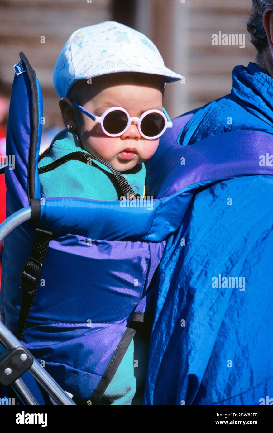 1990s BABY IN BACKPACK WEARING CAP AND SUNGLASSES - kb30866 LGA001 HARS ...