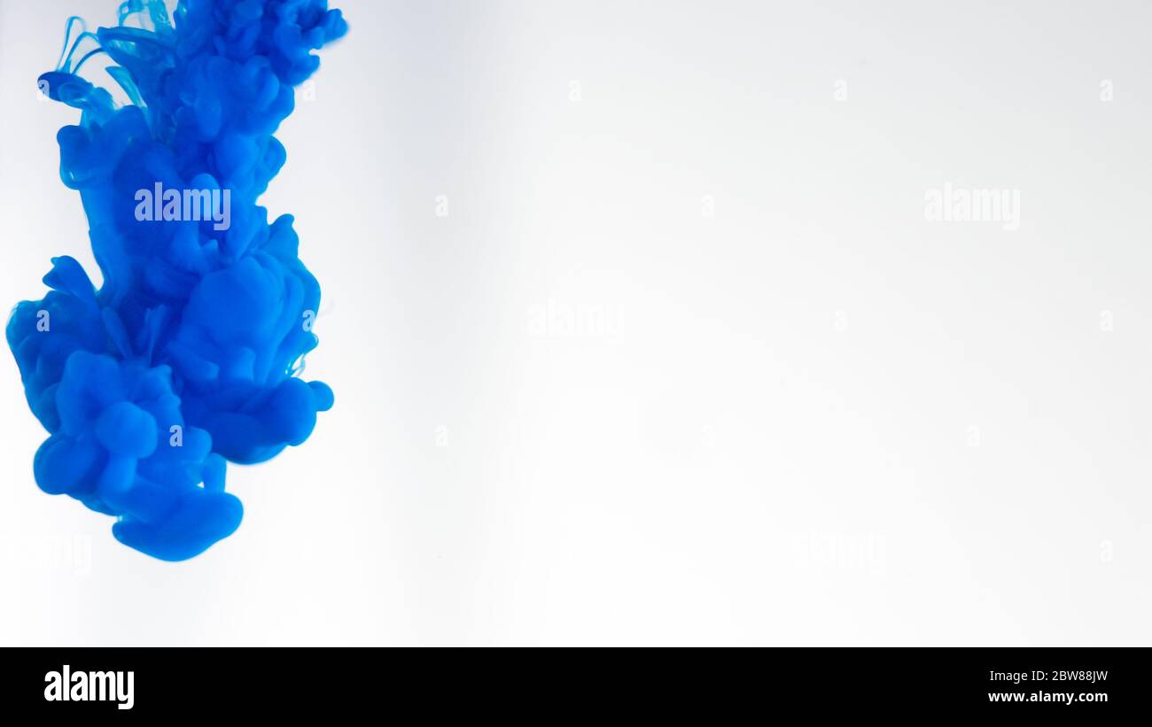 Cloud of blue color ink in water isolated on white. Abstract design and ...