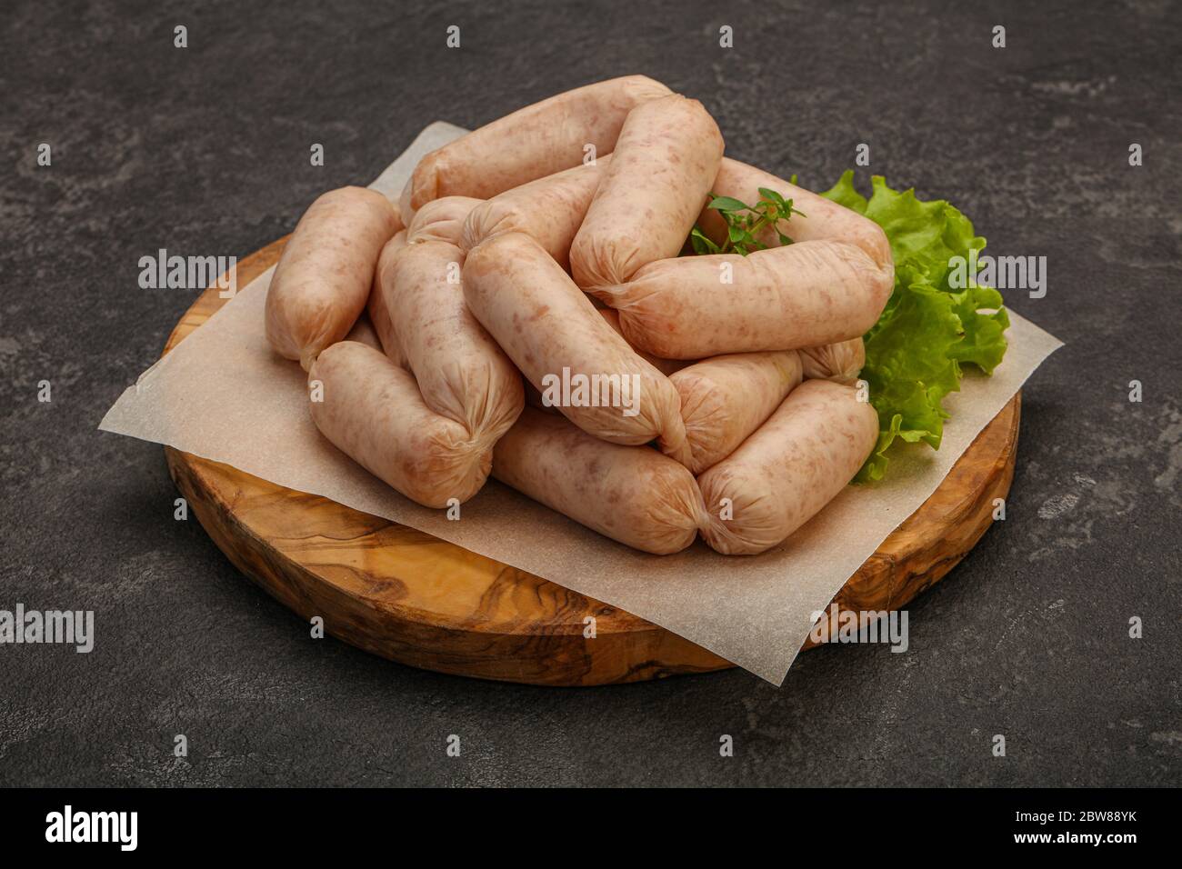 Raw natural chicken baby sausages for roast Stock Photo - Alamy